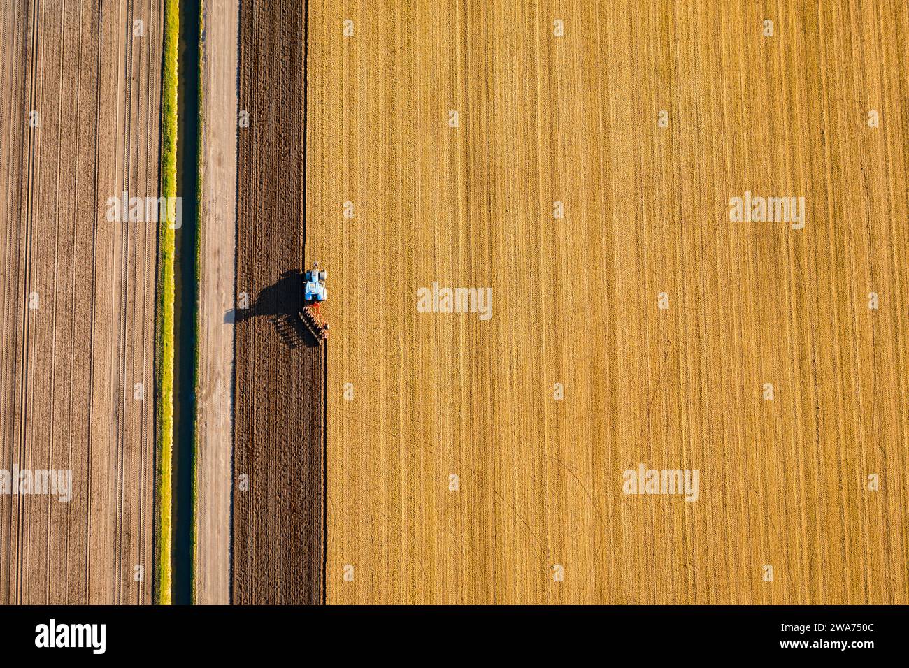 aerial overhead view of a tractor harvesting on a field Stock Photo - Alamy