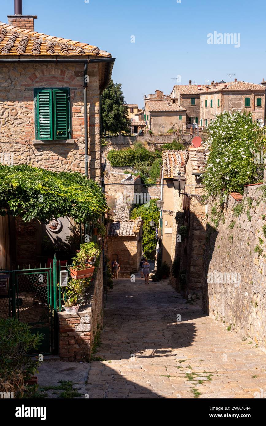 Narrow alley at the city wall of Volterra, Tuscany in Italy Stock Photo ...
