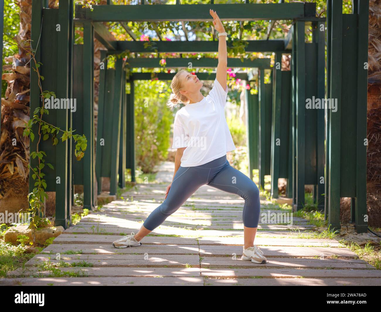 Young woman leading healthy lifestyle and practicing yoga, performs the ...