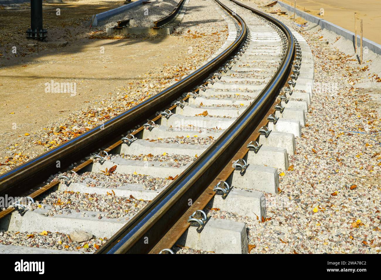 New streetcar rail track laying in city street on new concrete sleepers ...