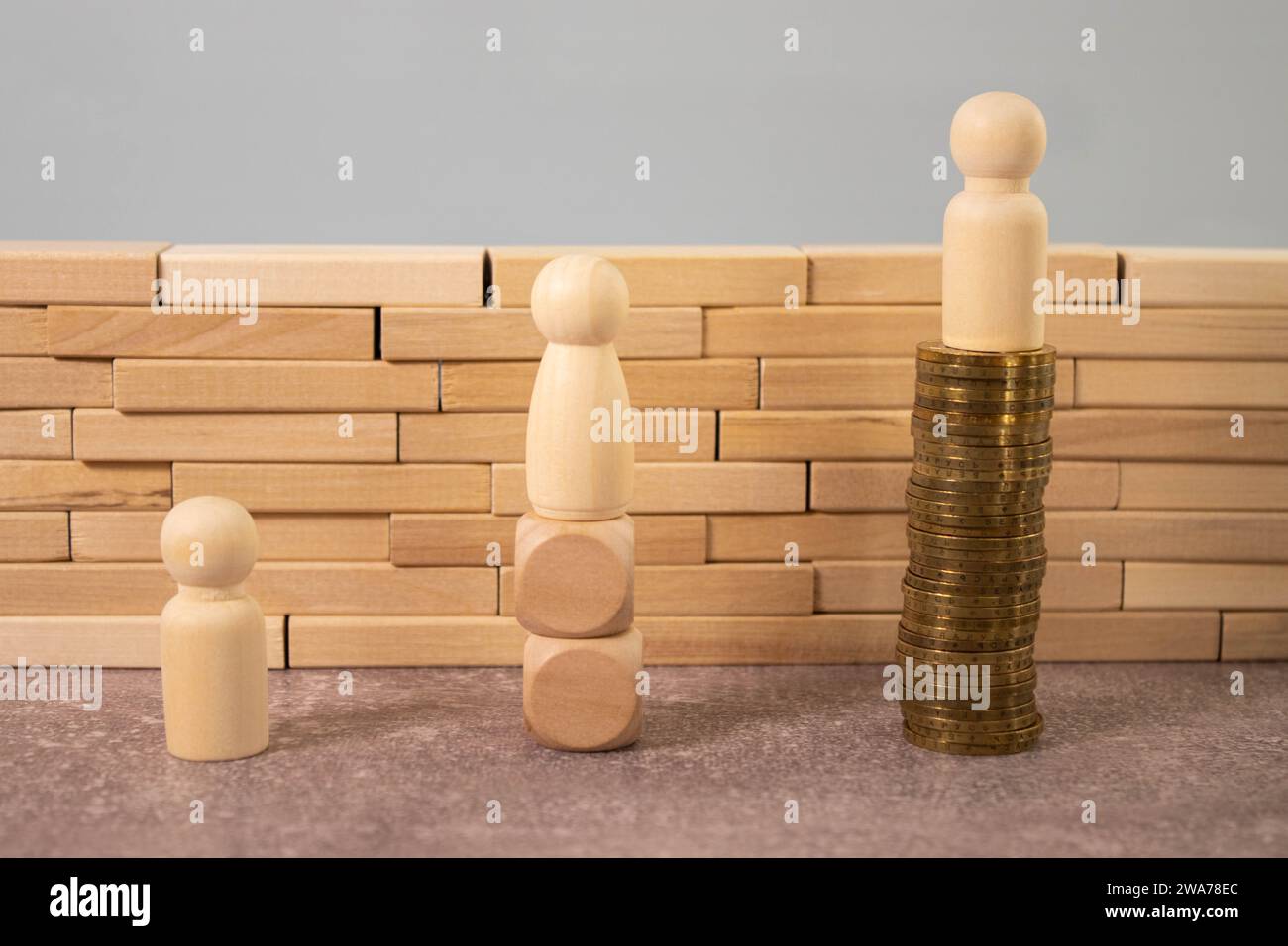 Miniature people standing on high and low. the gap between rich and ...