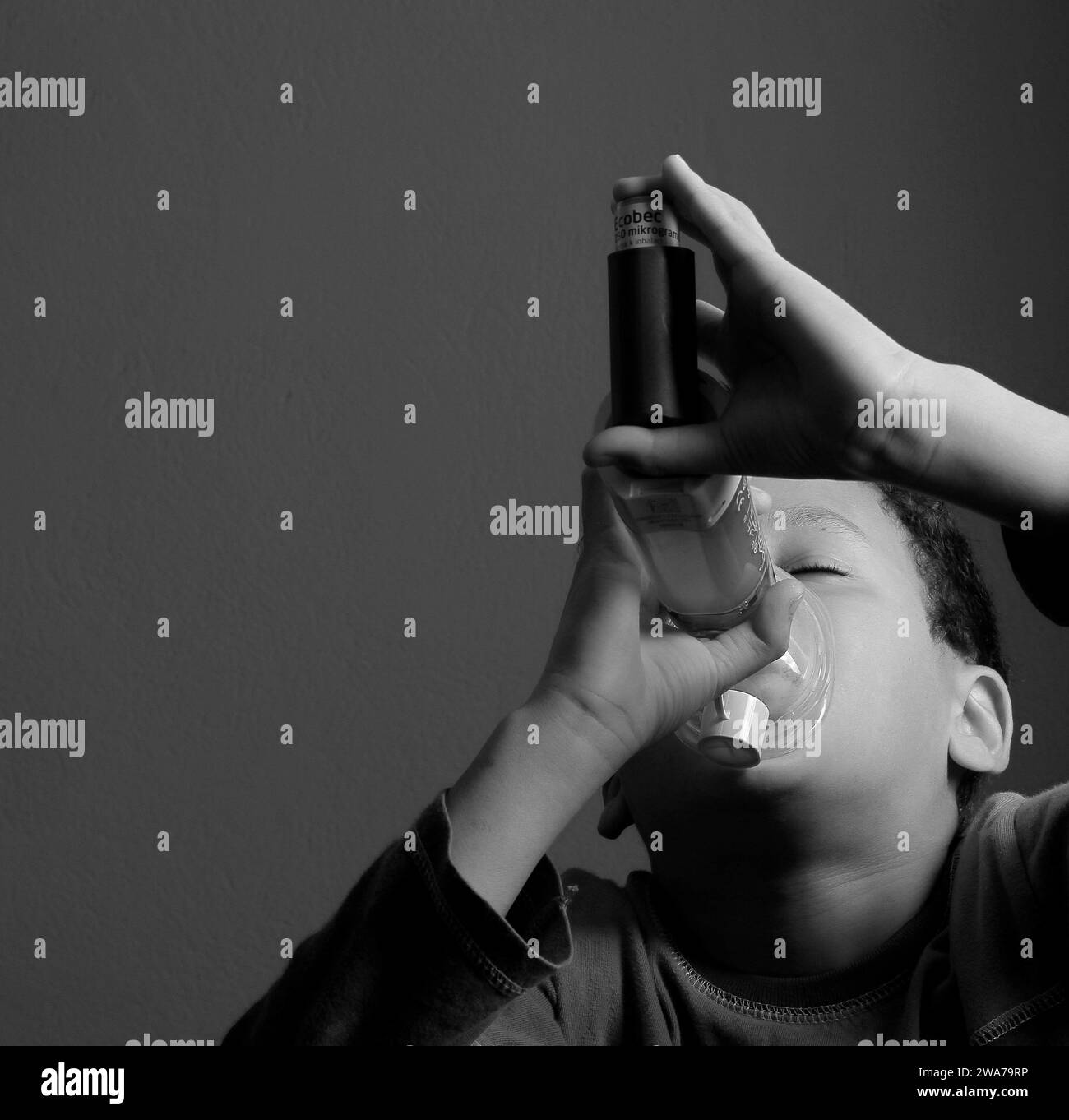 child with flu with inhaler respiratory puff on grey background with ...