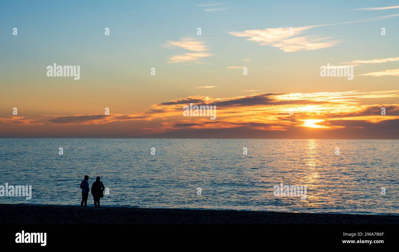 Person walking along the beach in the town of Calahonda, Granada, at ...