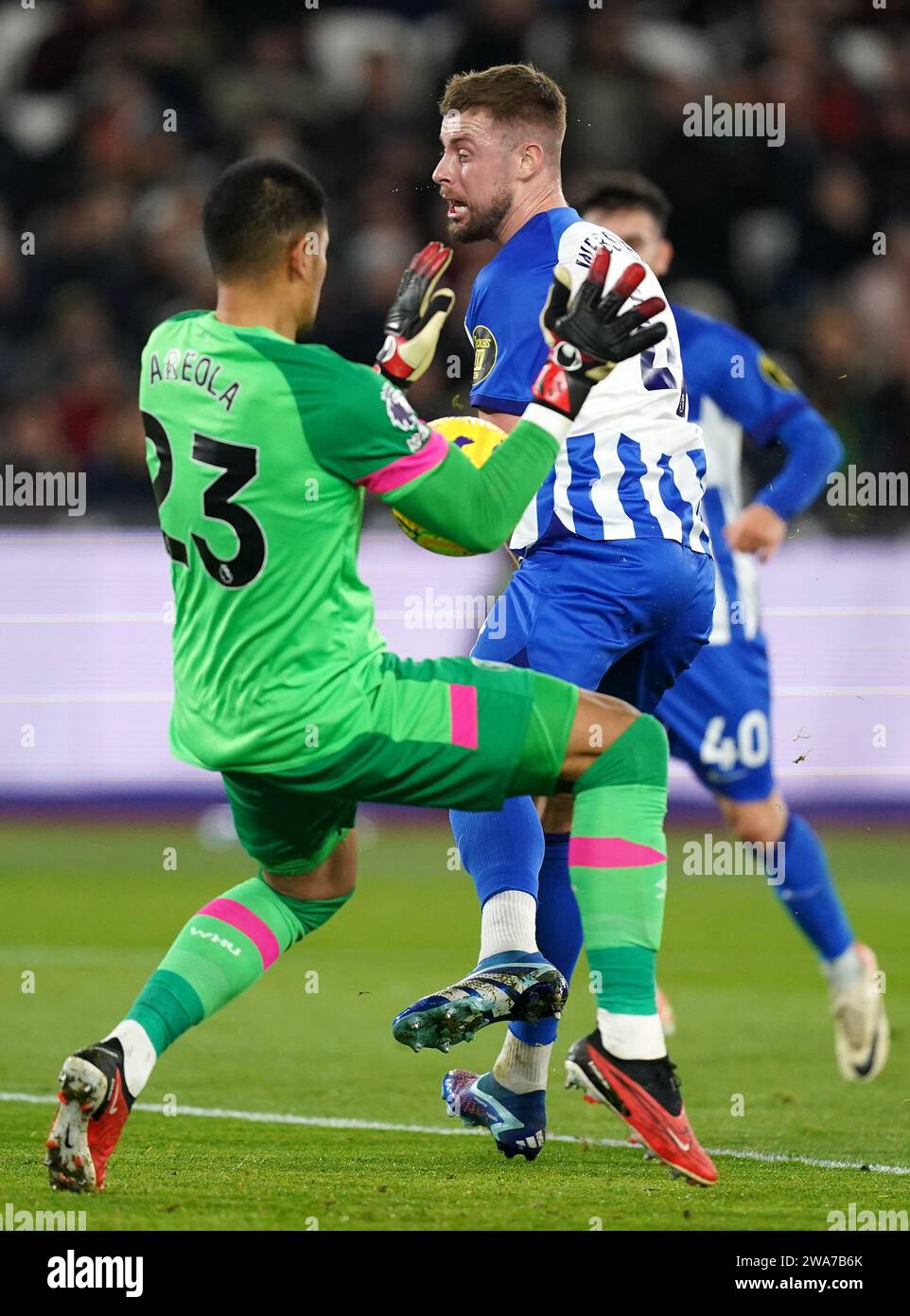 West Ham United goalkeeper Alphonse Areola (left) makes a save from ...