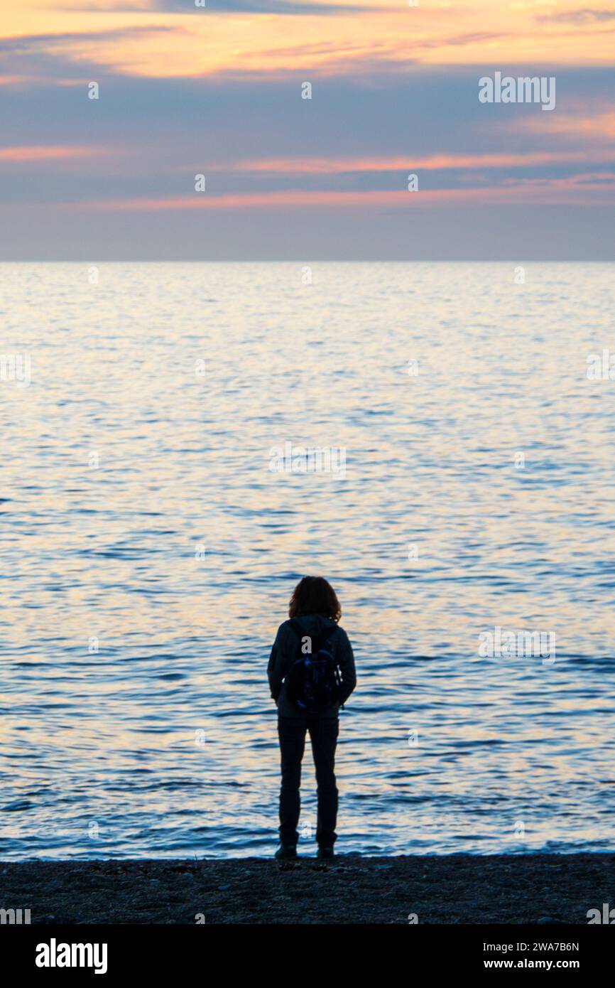 Person walking along the beach in the town of Calahonda, Granada, at ...
