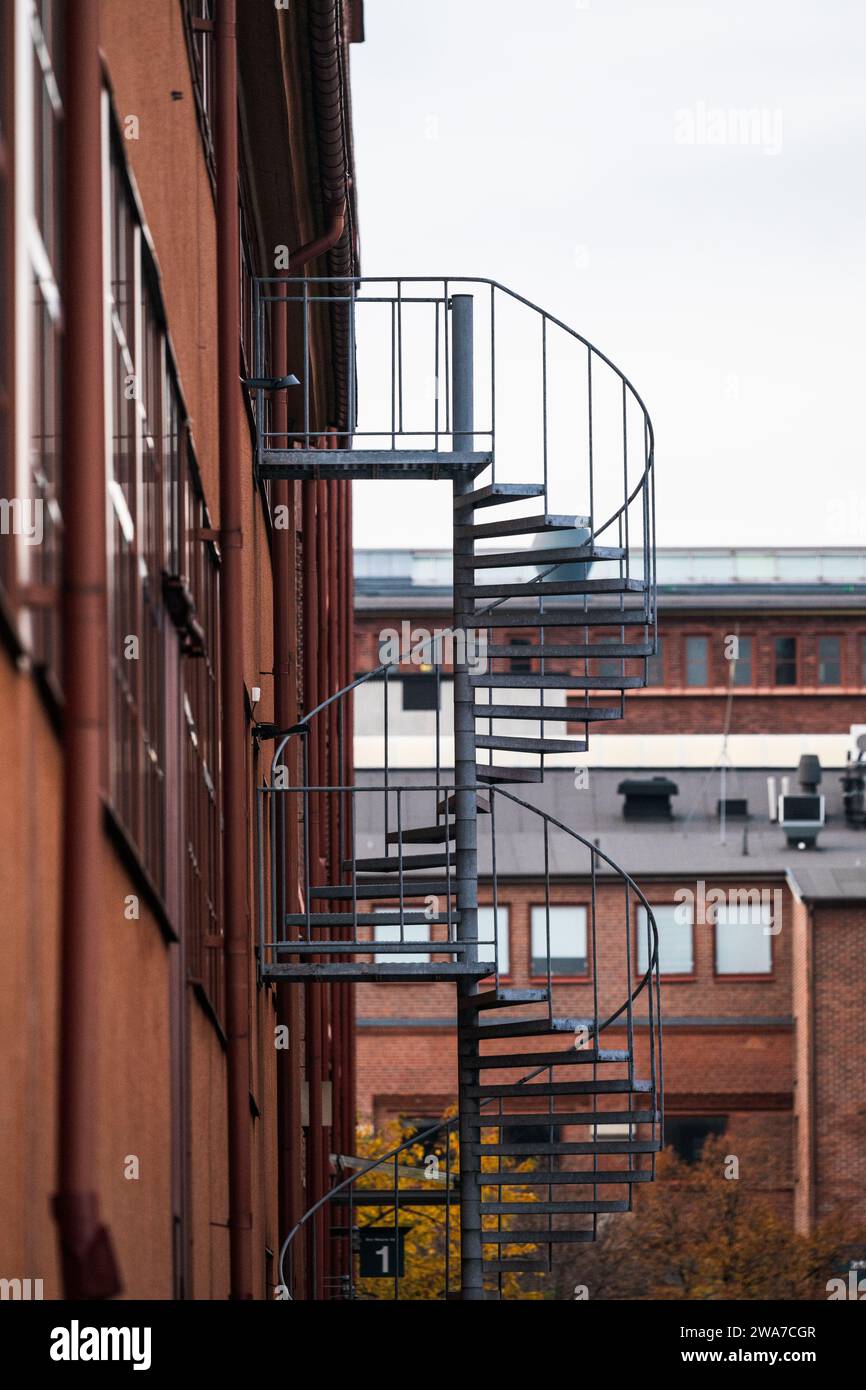 Spiral emergency stairs on the side of a warehouse Stock Photo - Alamy