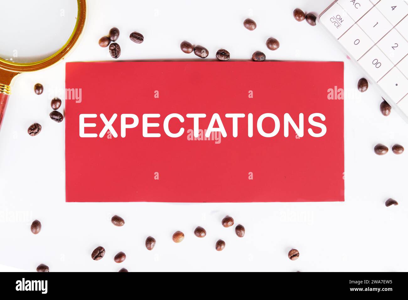 EXPECTATIONS writing on a red card on a white background with coffee ...