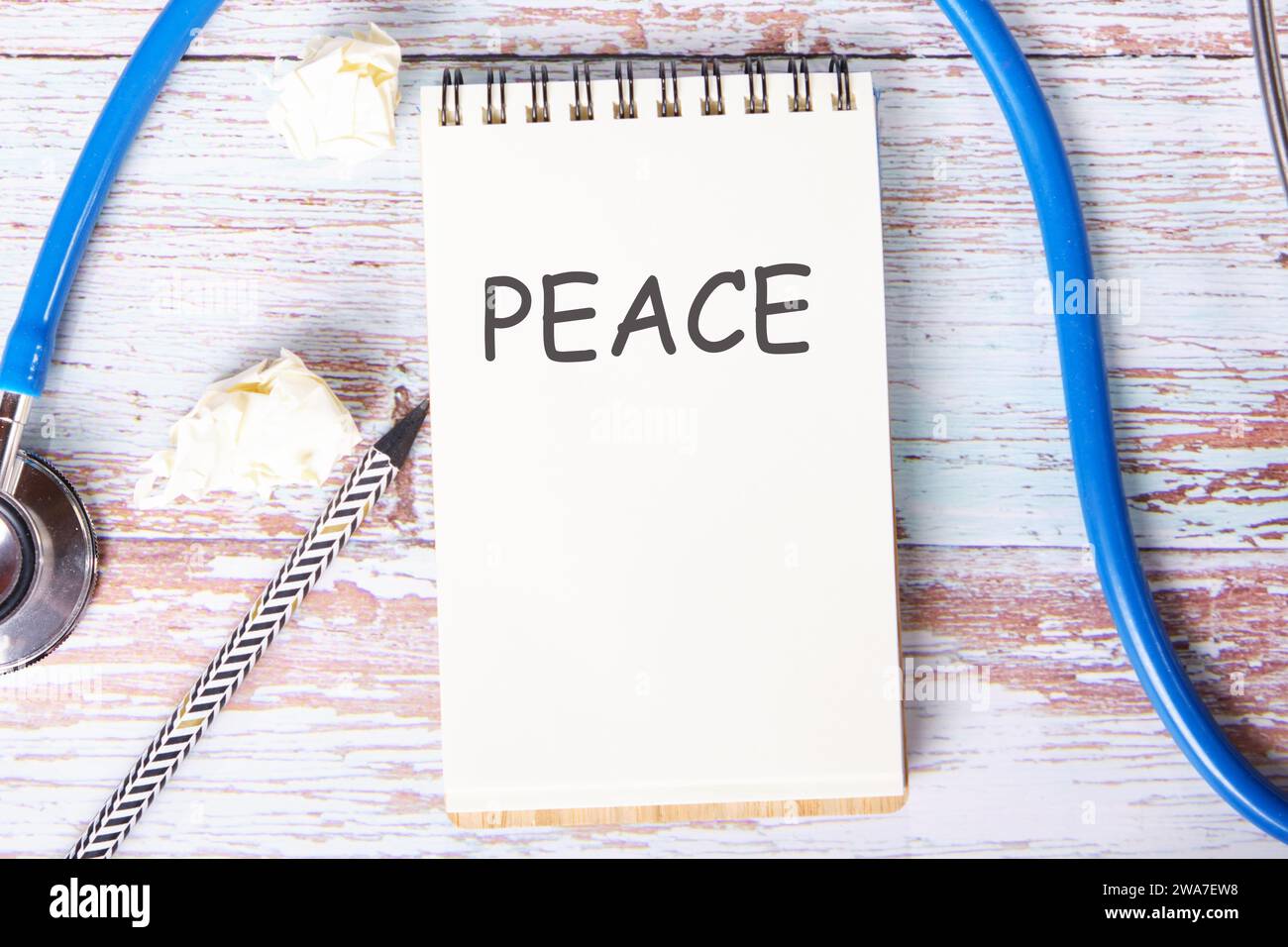 PEACE the text is written on a notebook that lies on old vintage boards ...