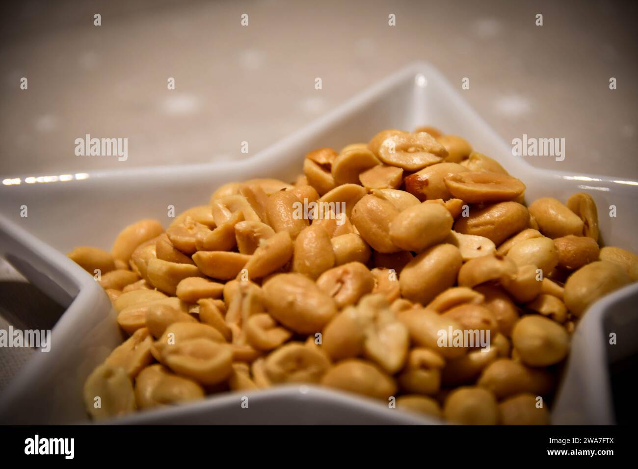 Peanuts in a star shaped dish Stock Photo - Alamy