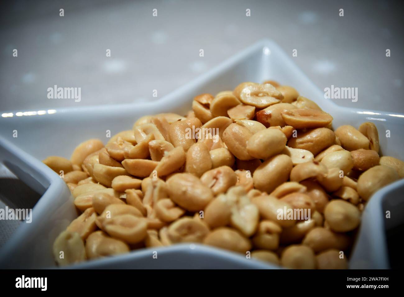 Peanuts in a star shaped dish Stock Photo - Alamy