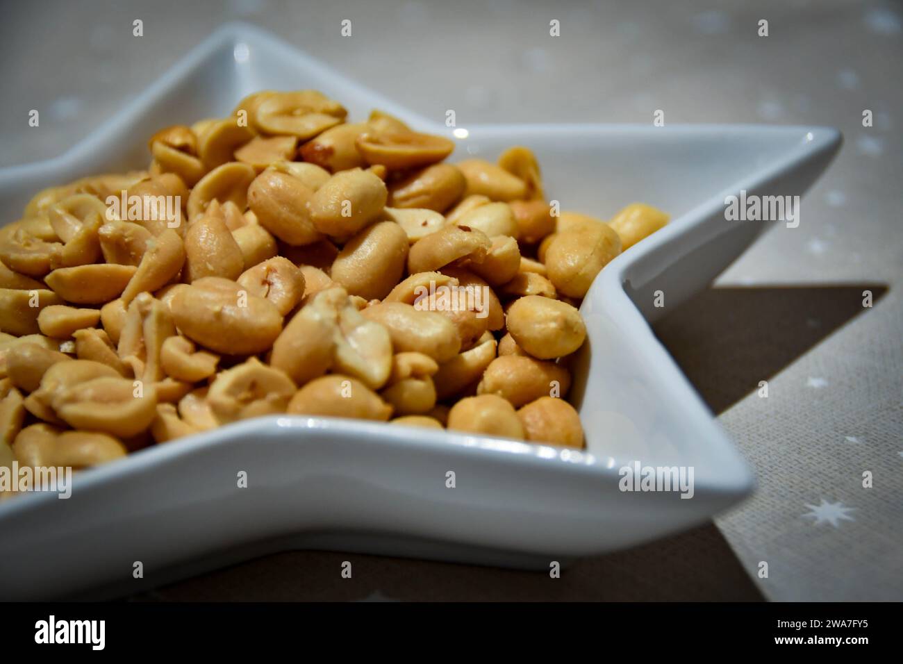 Peanuts in a star shaped dish Stock Photo - Alamy