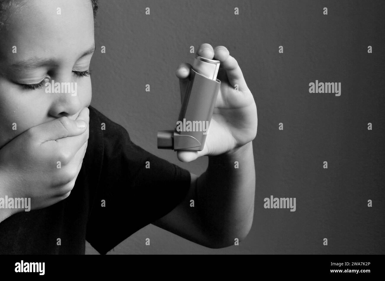 child with flu with inhaler respiratory puff on grey background with ...