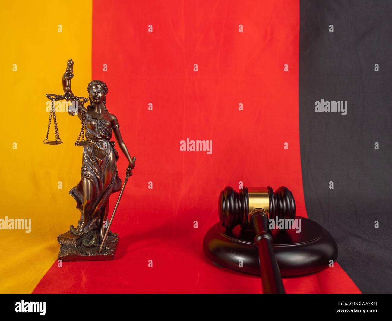 Bronze statue of justice and judge's gavel against the background of ...
