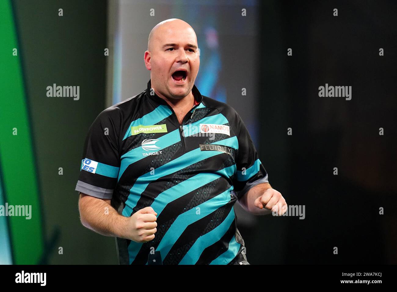 Rob Cross reacts during his match against Luke Littler (not pictured ...