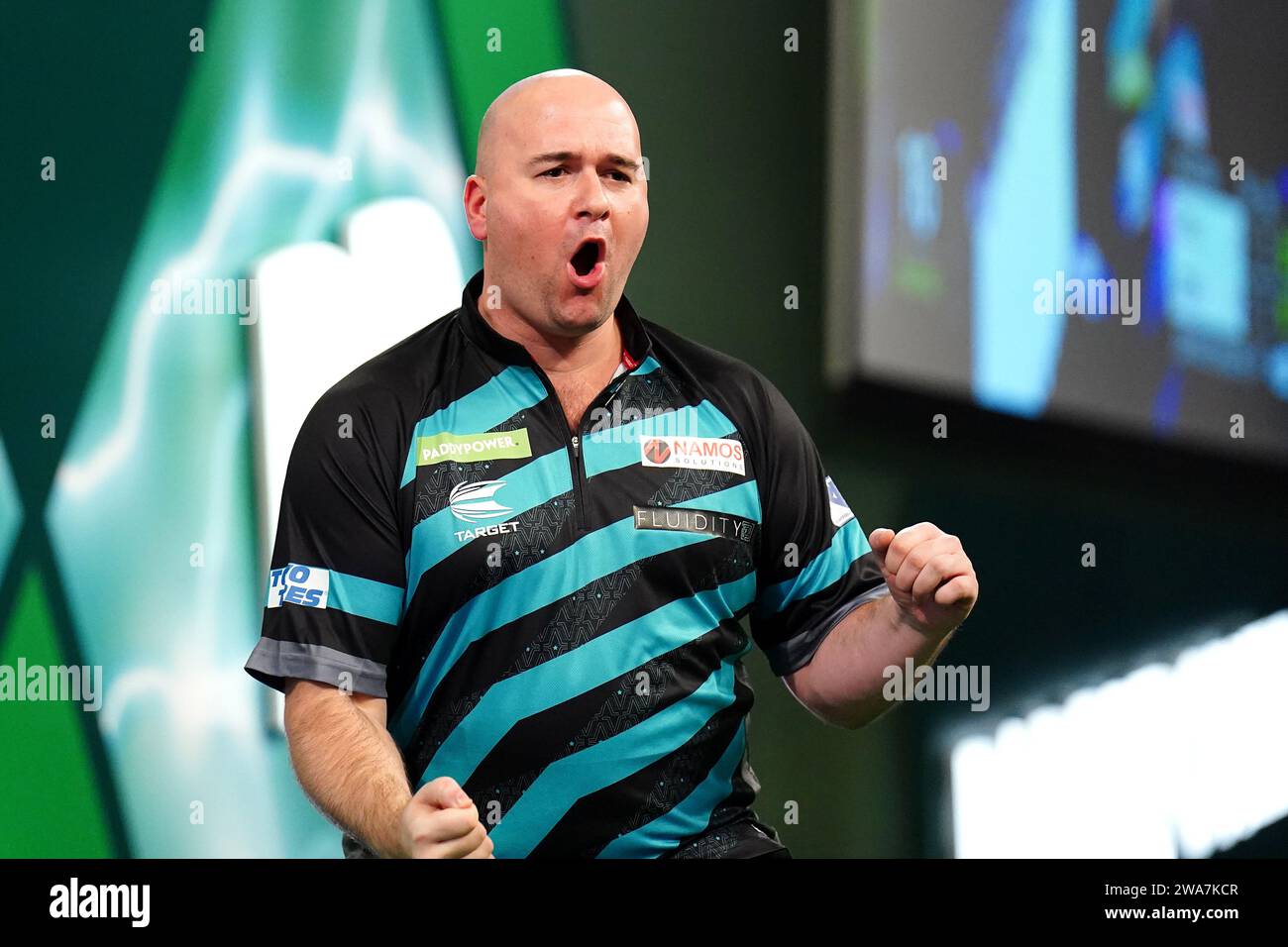 Rob Cross reacts during his match against Luke Littler (not pictured ...