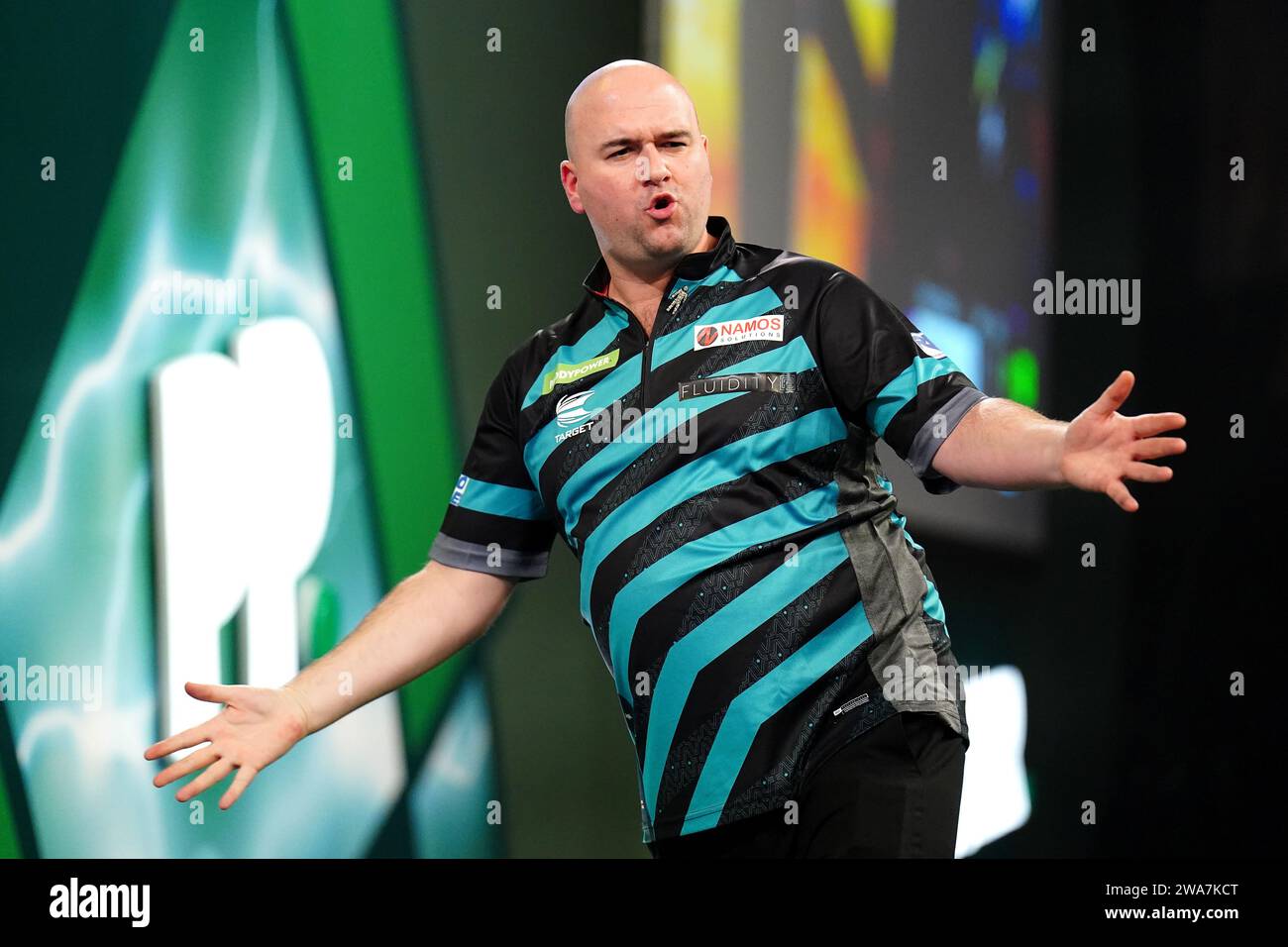 Rob Cross reacts during his match against Luke Littler (not pictured ...