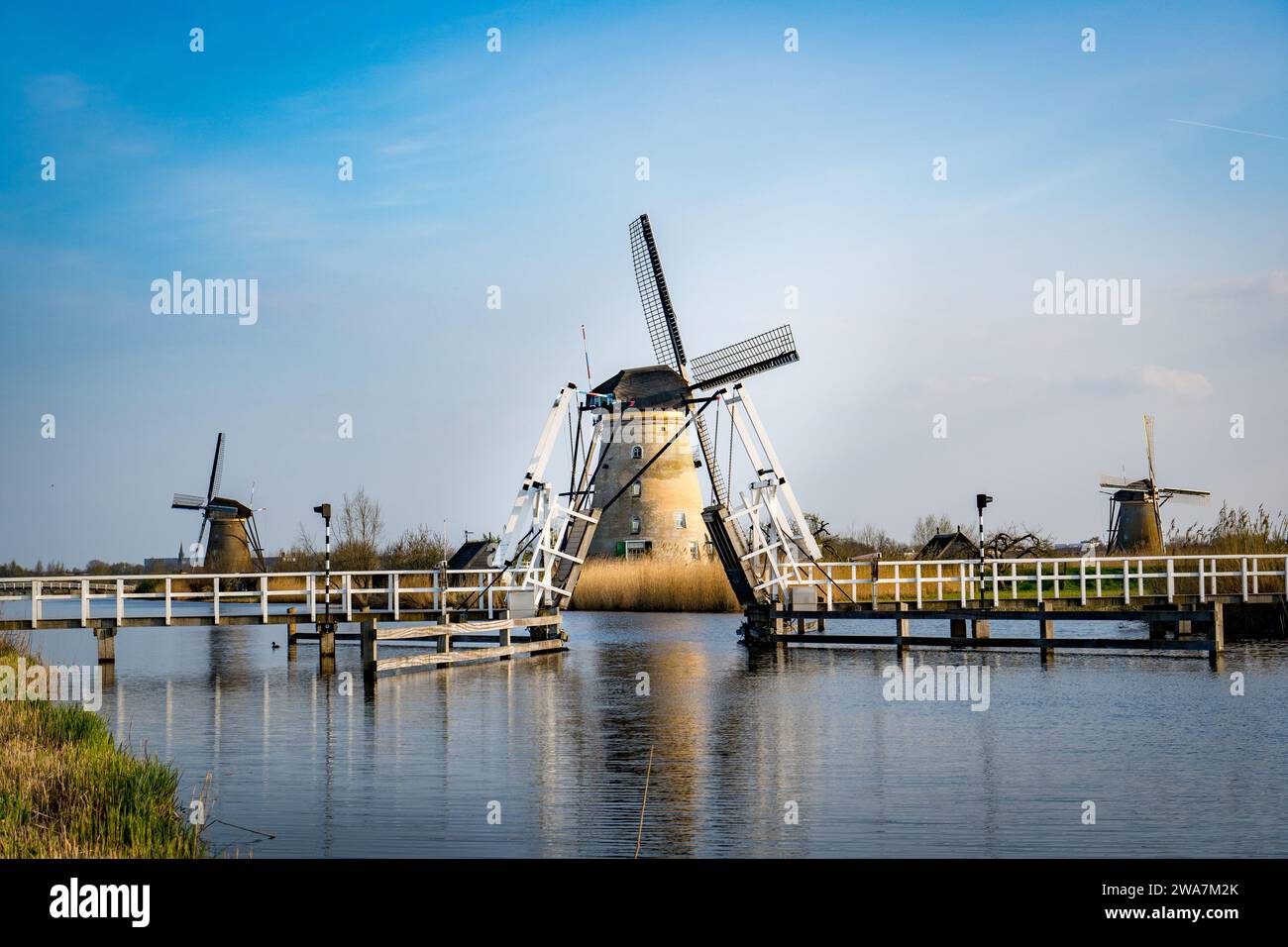 dutch windmill across a river Stock Photo - Alamy