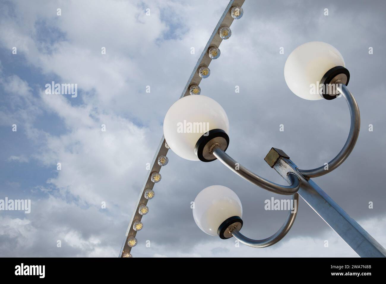 Light bulbs and street lights and cloudy sky on background Stock Photo ...