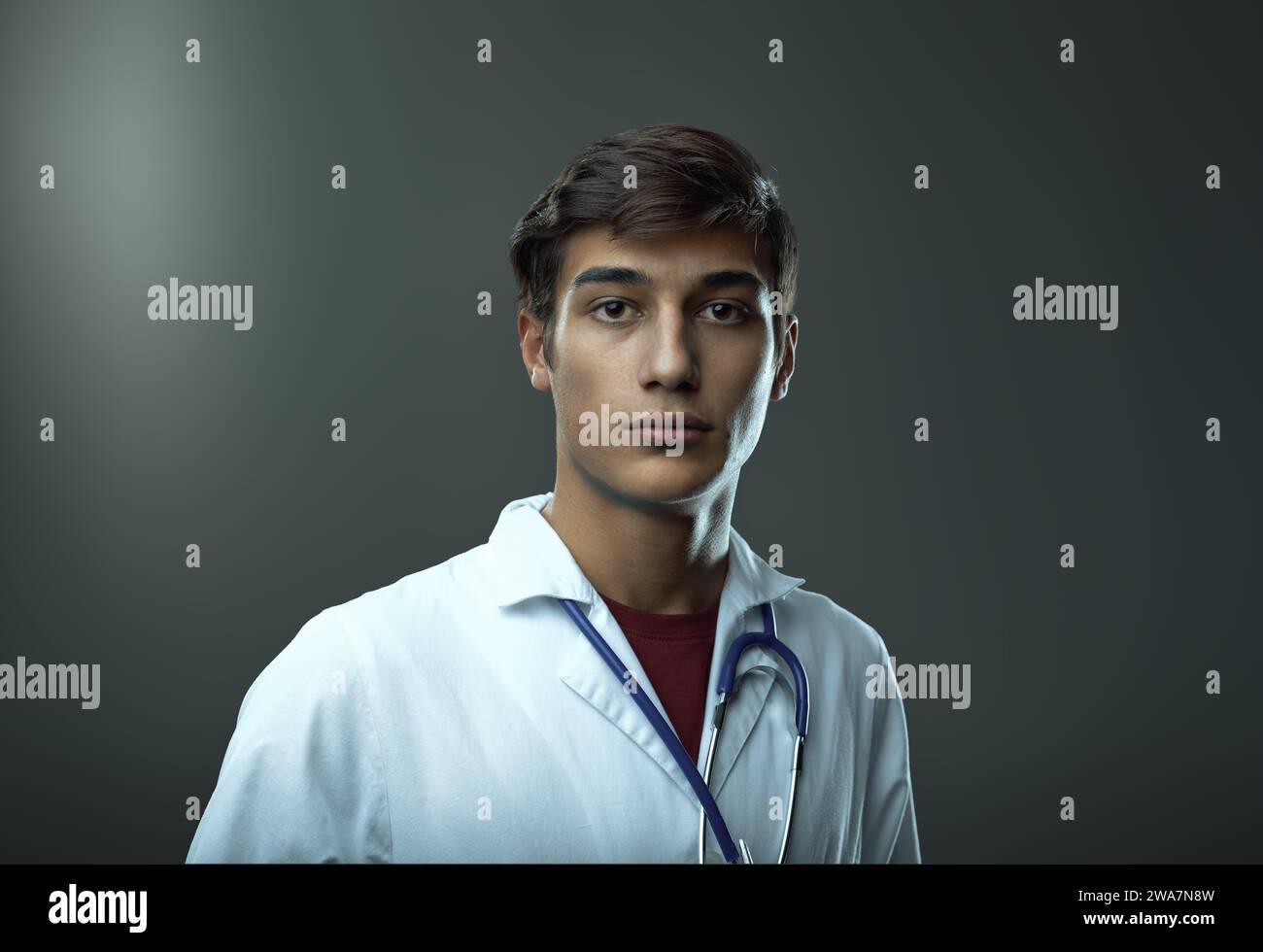Clad in a white lab coat with a stethoscope, the young man portrays the ...