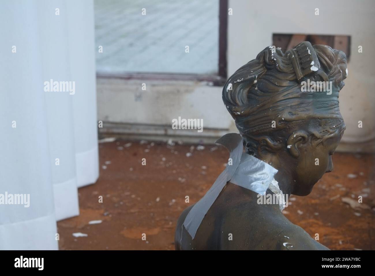 Busted female bust fixed with duct tape in a dirty shabby deserted shop ...