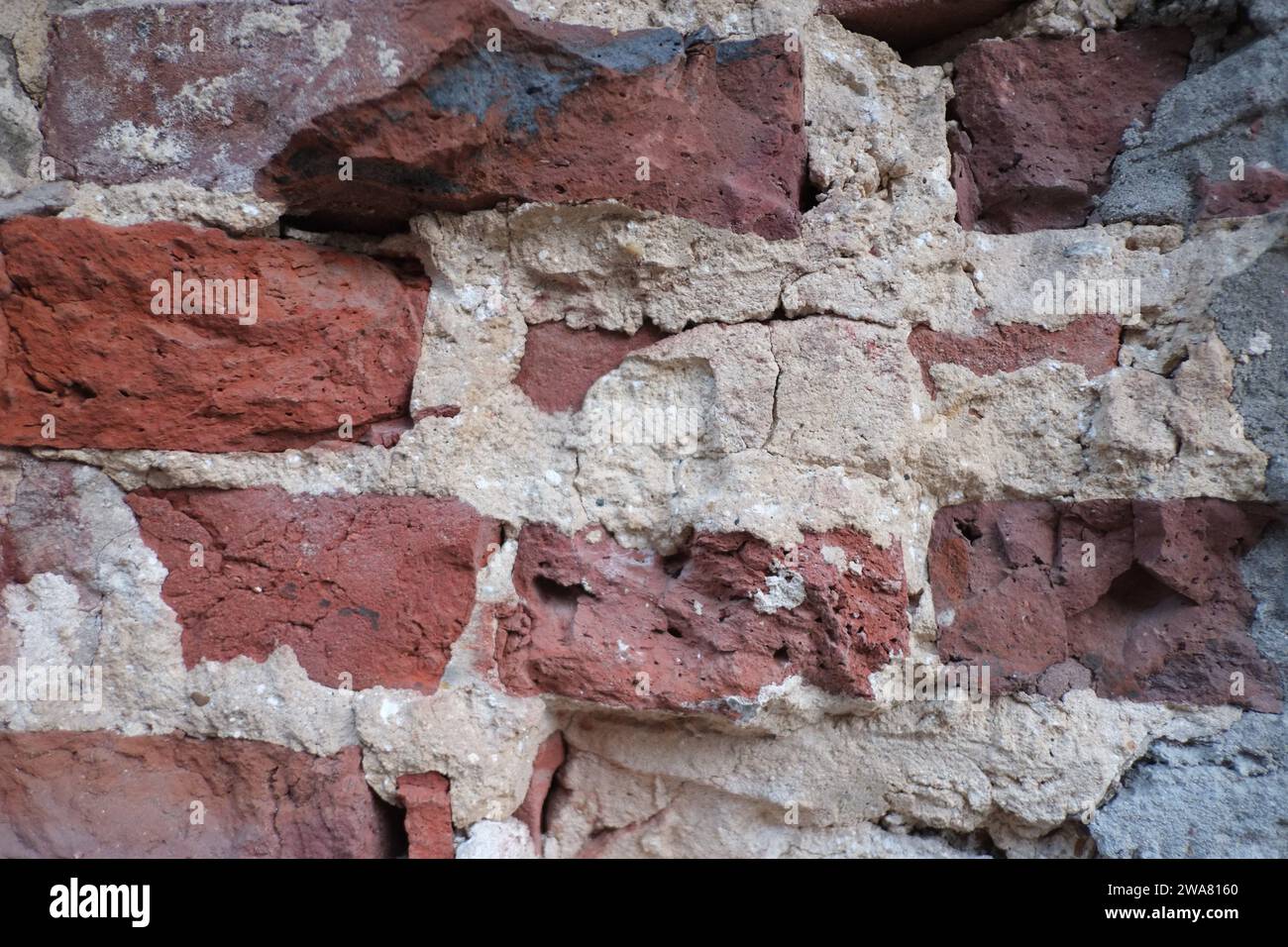 close up of an urban textured, damaged and grunge old brick stones with ...