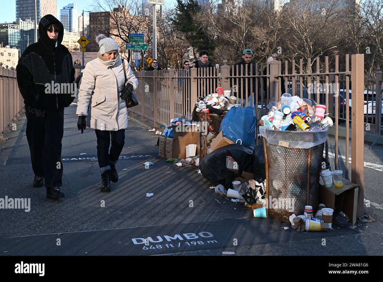 Overflowing trash cans on the Brooklyn Bridge pedestrian pathway on ...