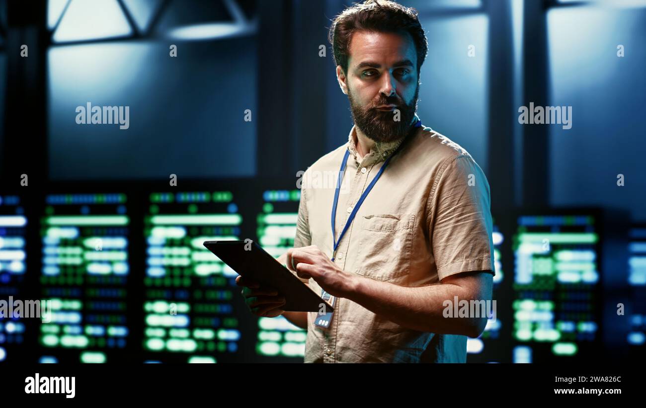 Engineer doing monitoring in server hub responsible with intense data ... Engineer doing monitoring in server hub responsible with intense data ...