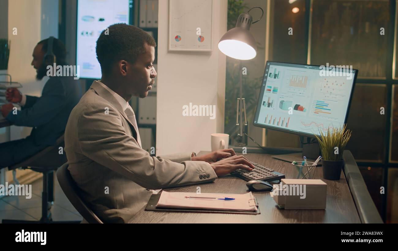 Employee stressed by coworker having fun at work, listening to music ...