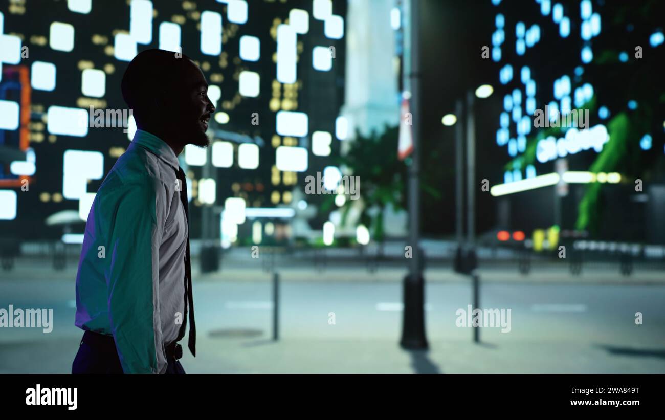 African american person on night walk downtown under streetlights ...