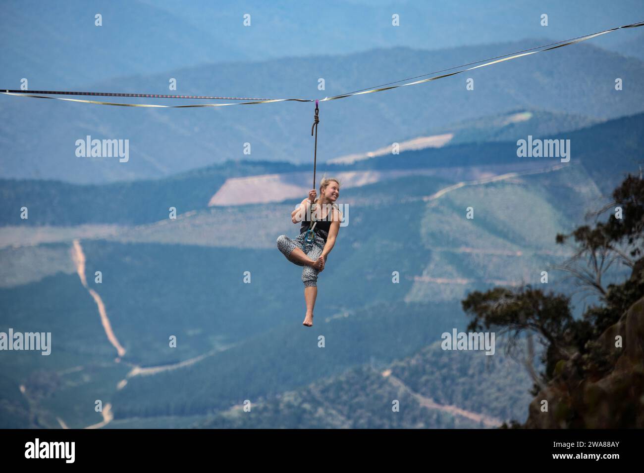 Slacklining across the Australian Alps. A slackliner balancing high at ...
