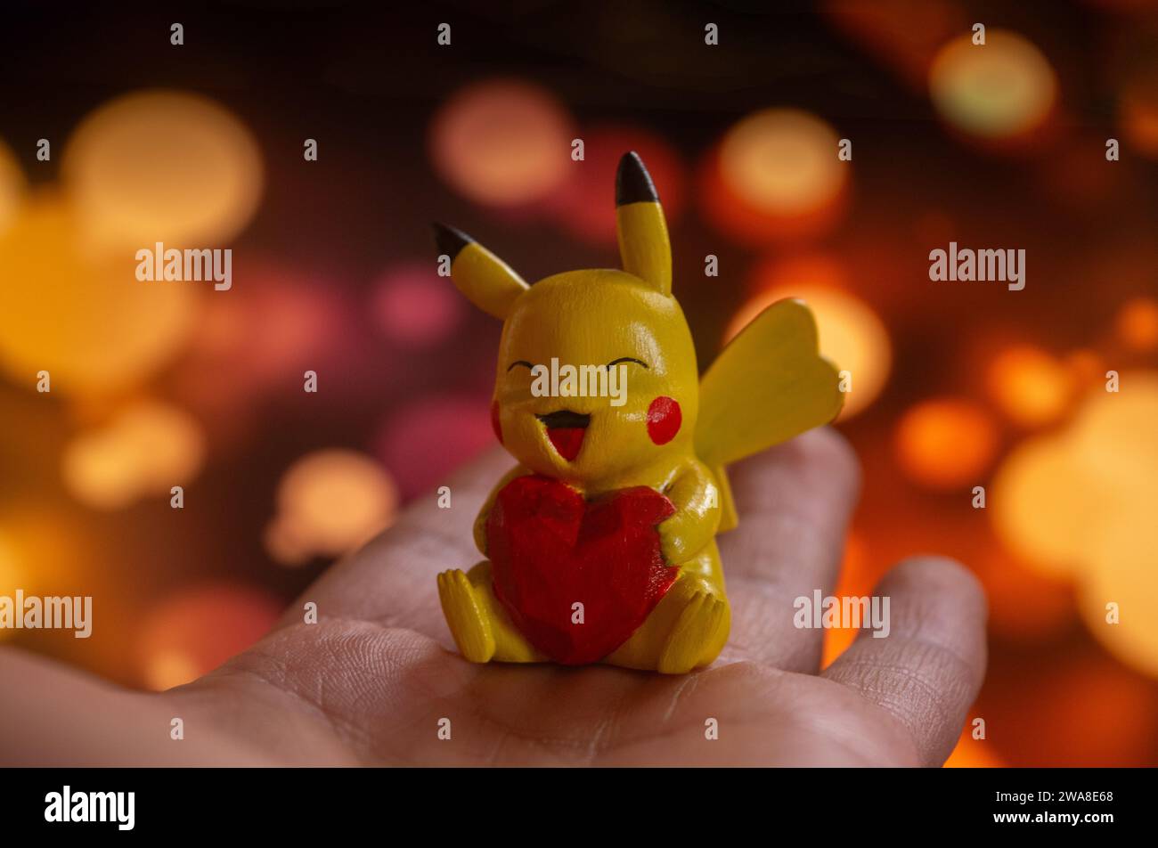 Pikachu in hand with love Stock Photo - Alamy