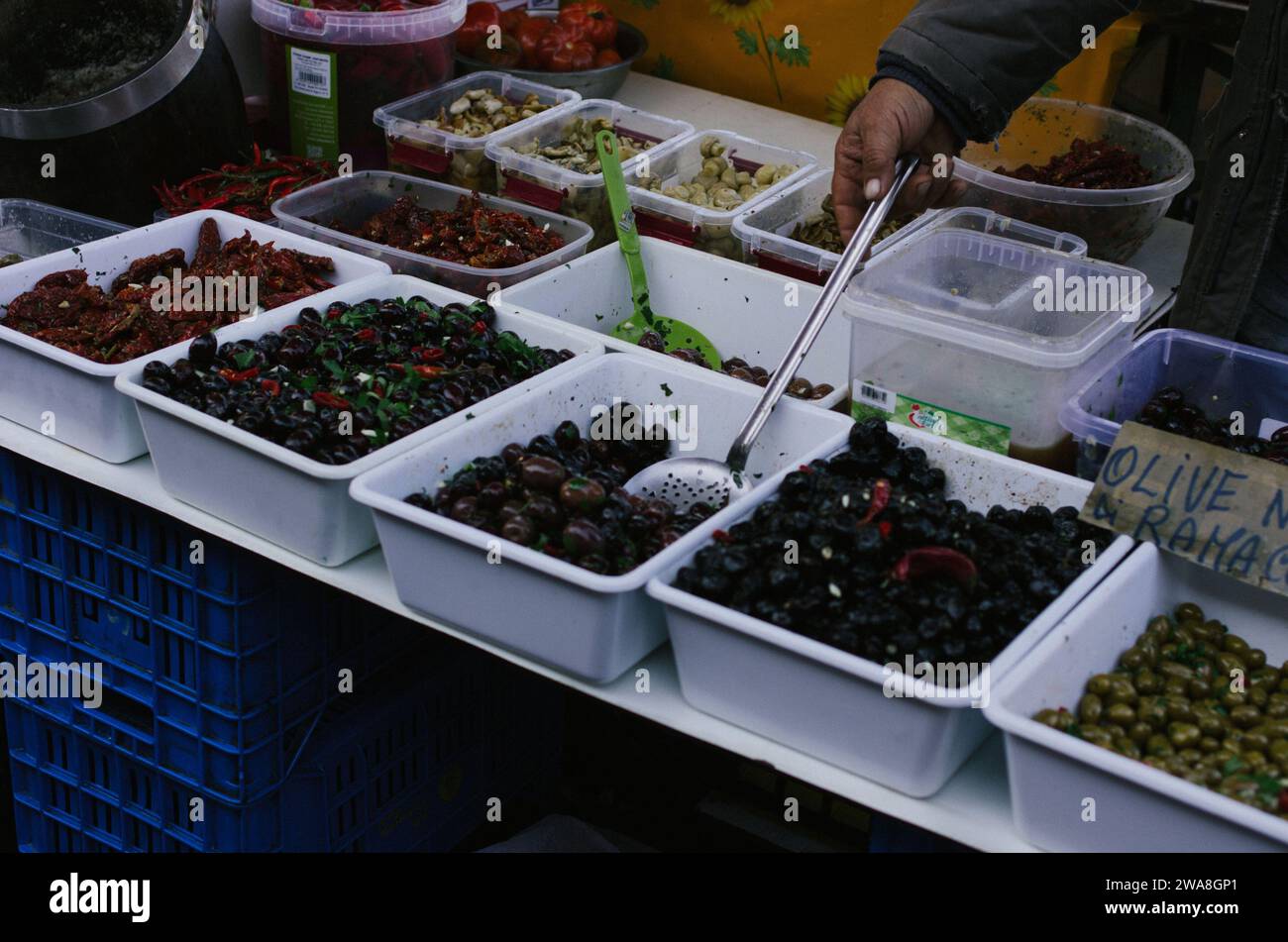 In the market, a myriad of olives creates a vibrant tapestry of colors ...