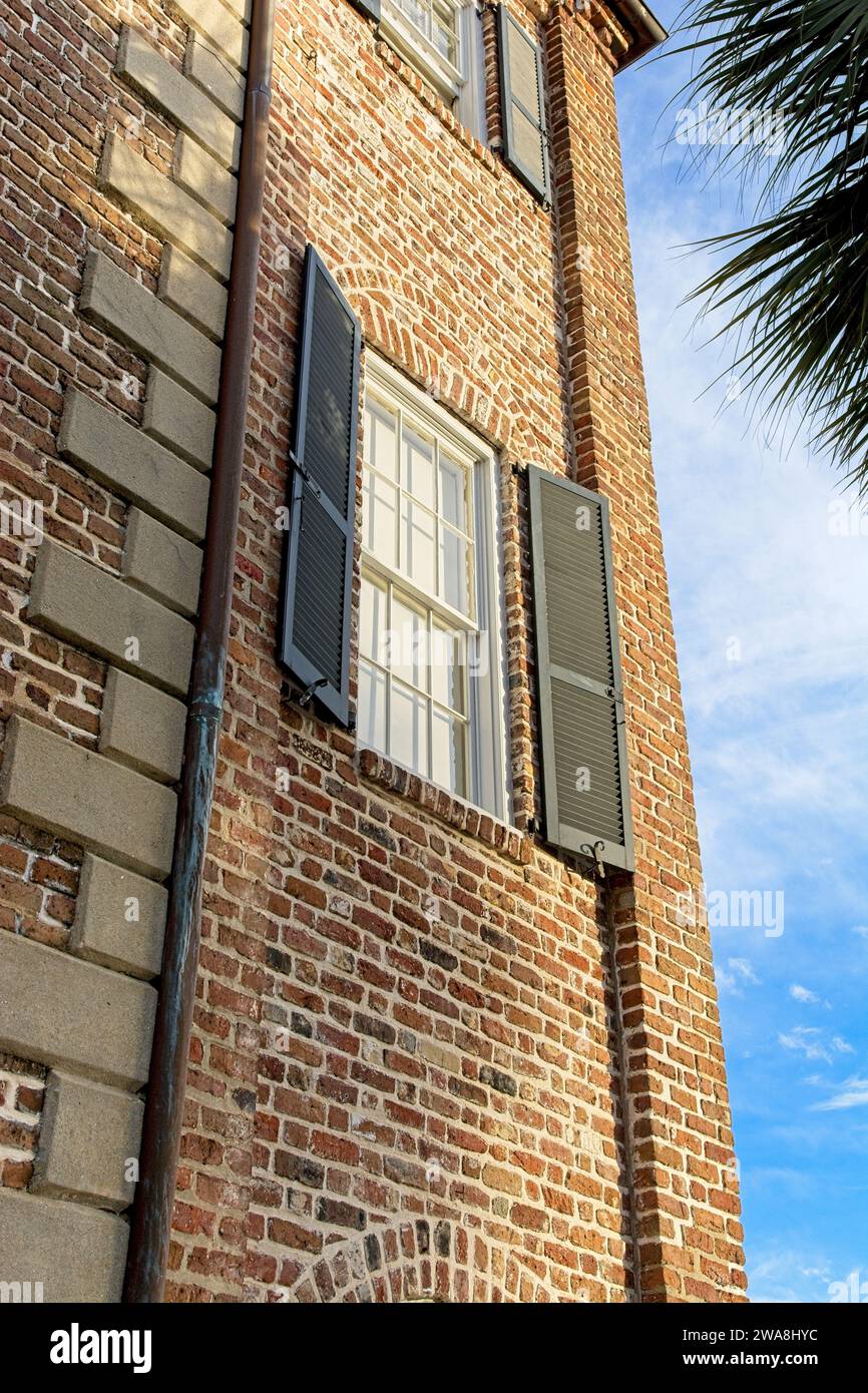 Sunlit window in brick wall of 18th century Federal style James ...