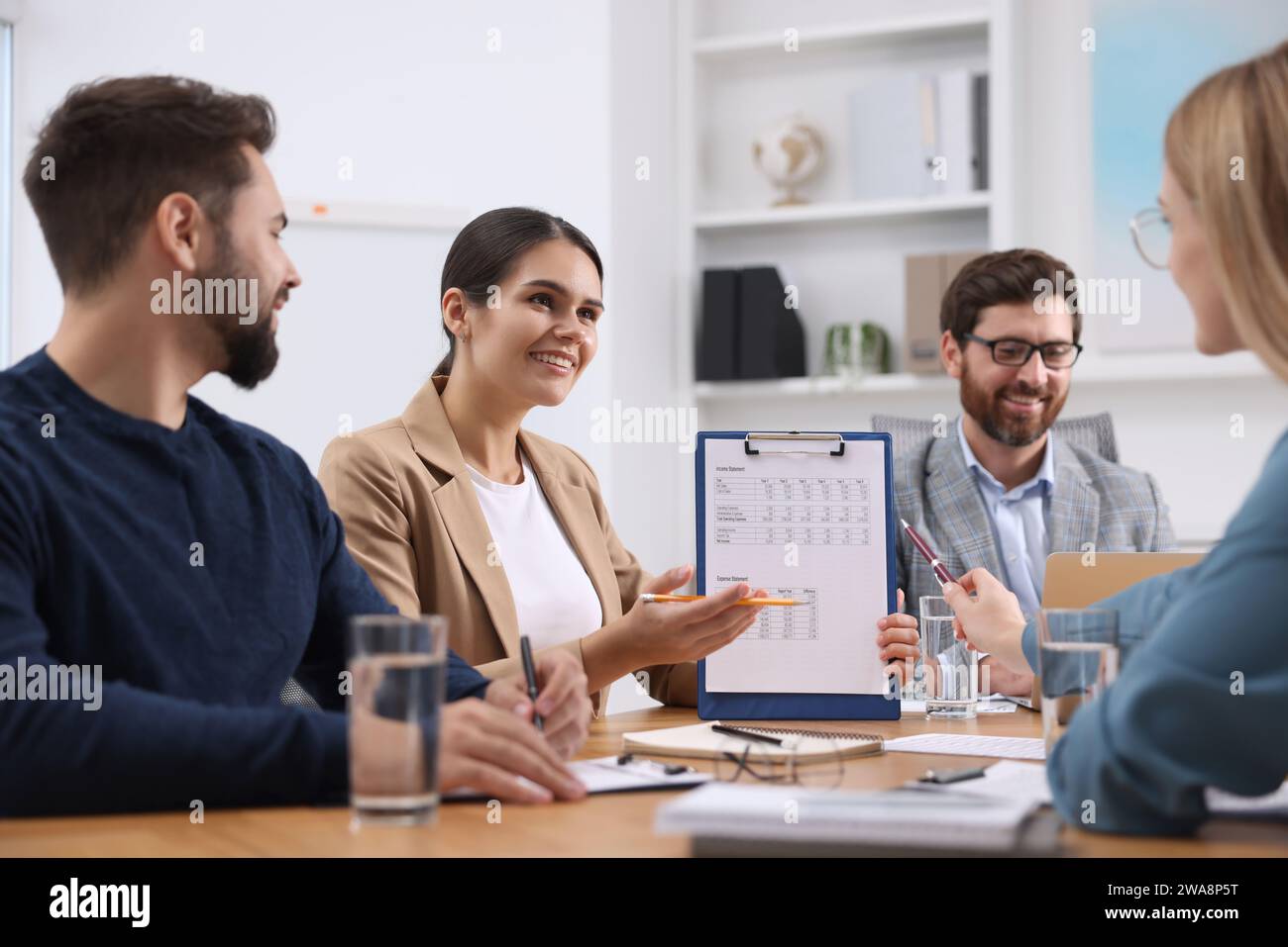 Team of employees working together in office Stock Photo - Alamy