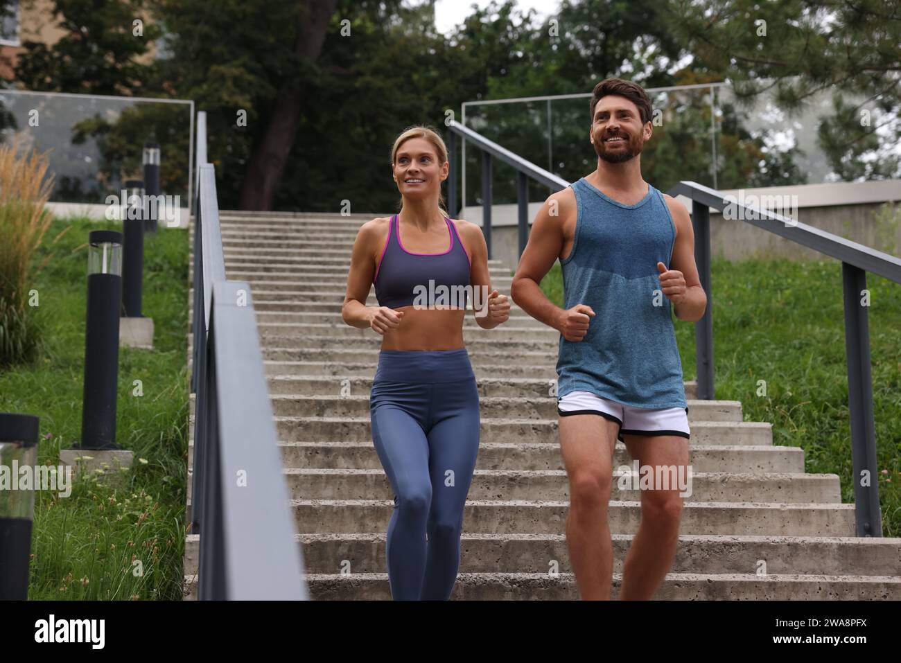 Healthy lifestyle. Happy couple running down stairs outdoors Stock ...