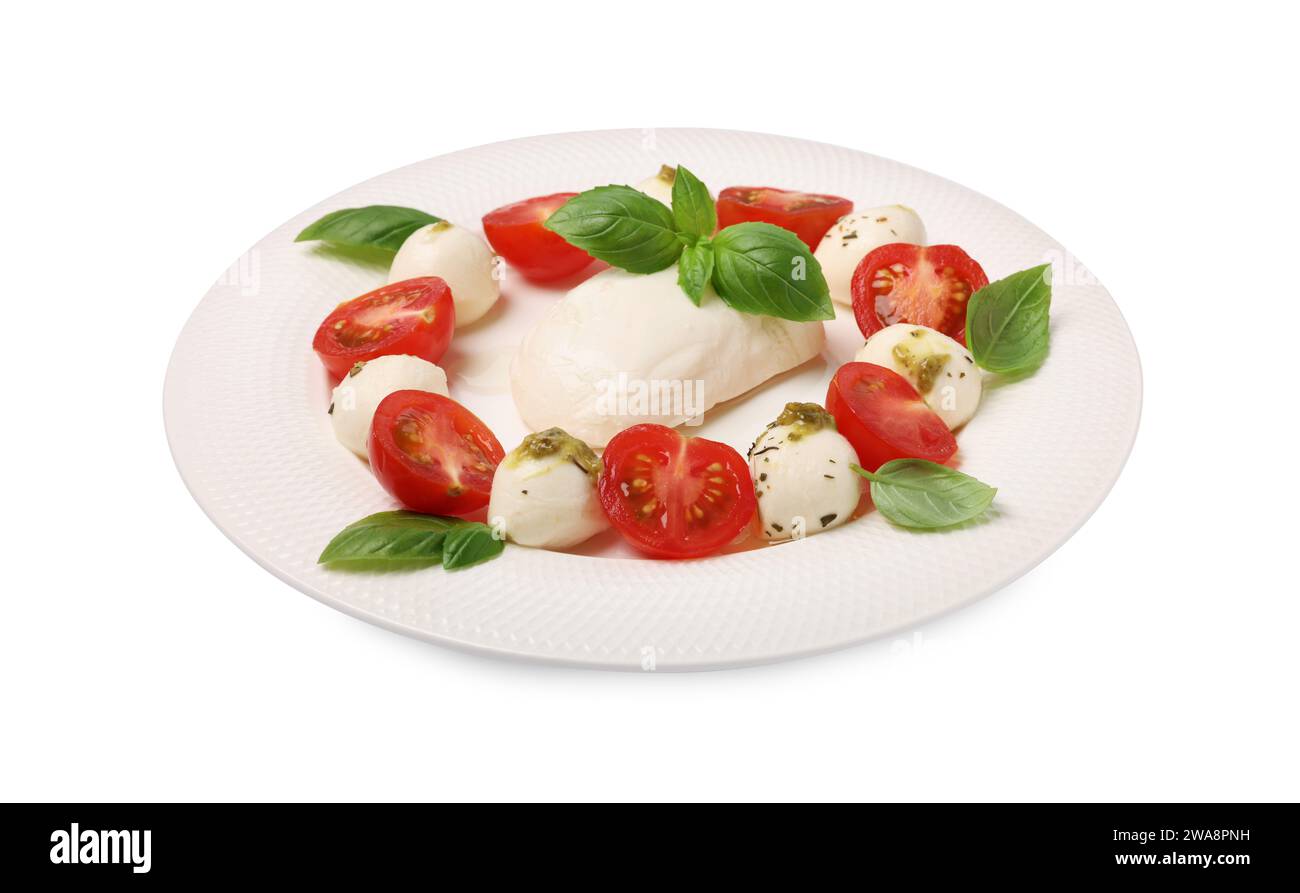 Plate of tasty Caprese salad with mozzarella, tomatoes, basil and pesto ...