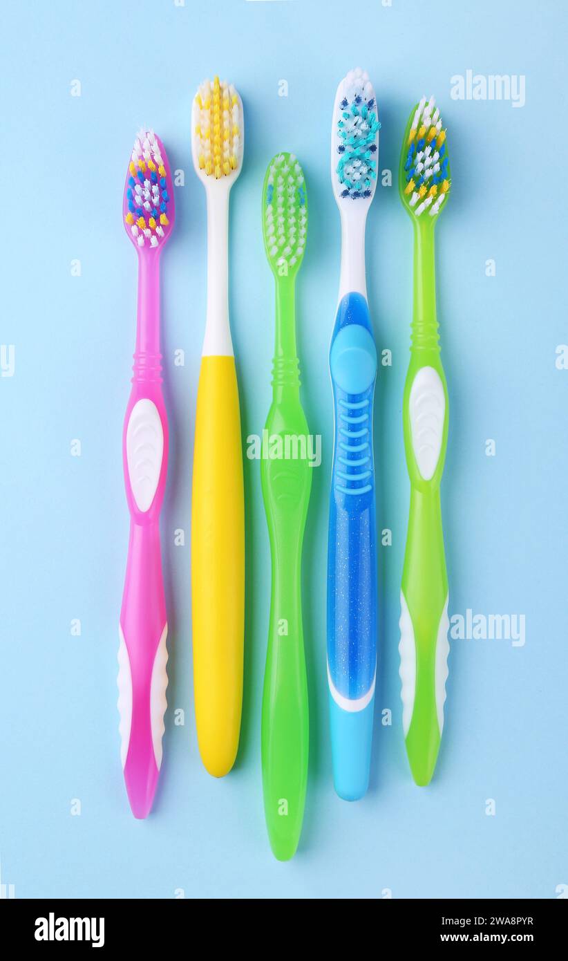 Many different toothbrushes on light blue background, flat lay Stock ...