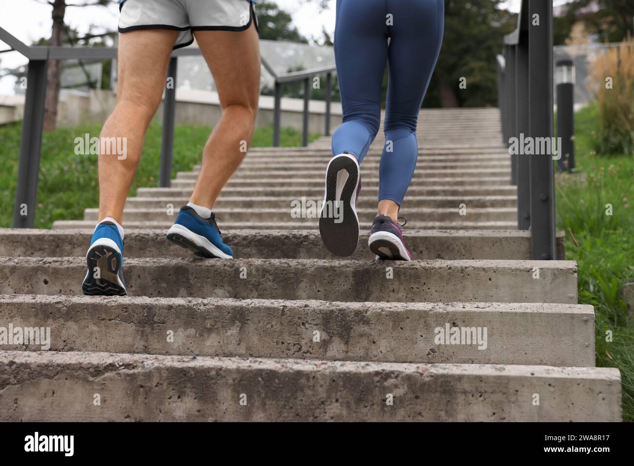 Healthy lifestyle. Couple running up stairs outdoors, closeup Stock ...