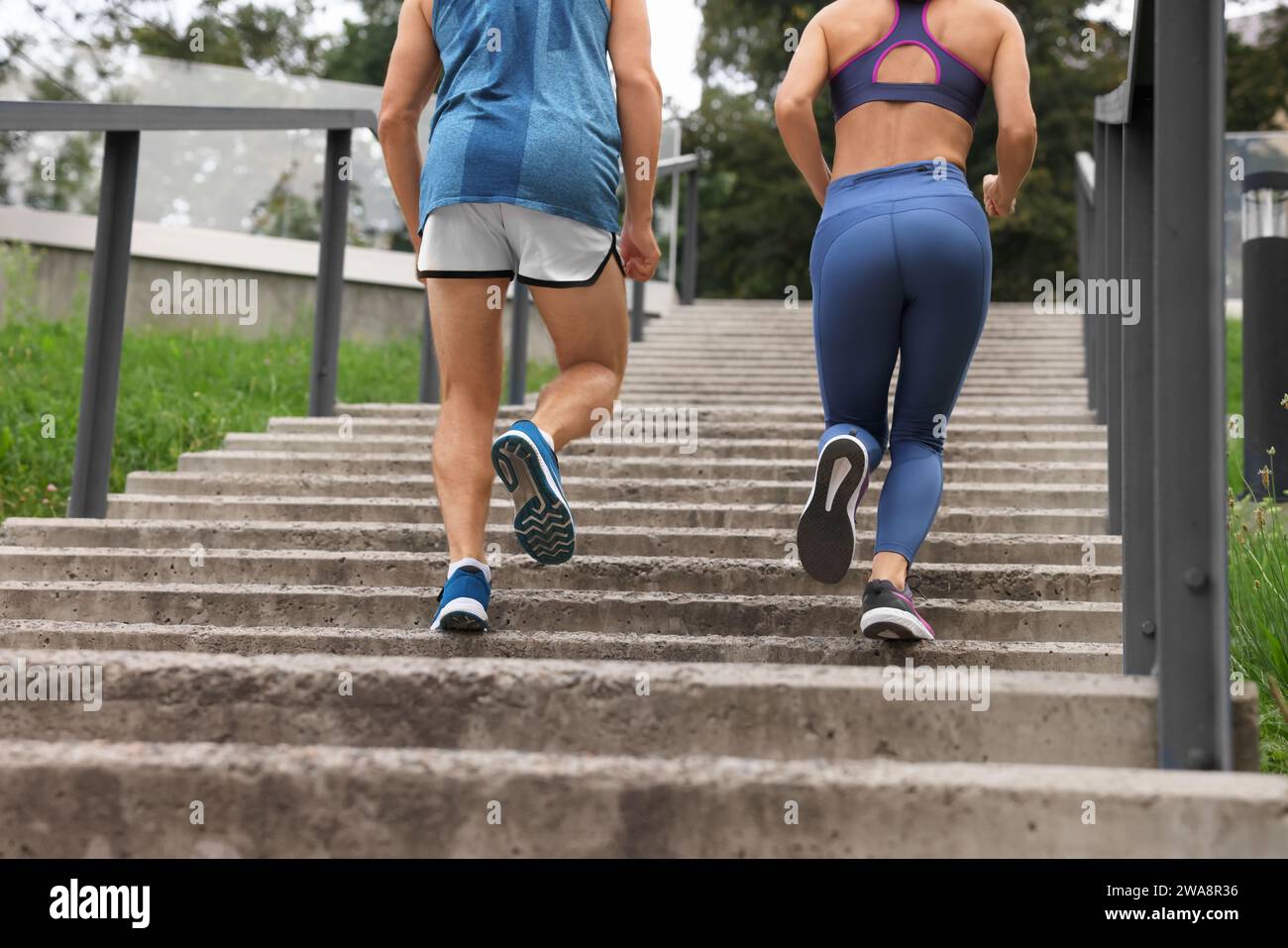 Healthy lifestyle. Couple running up stairs outdoors, closeup Stock ...
