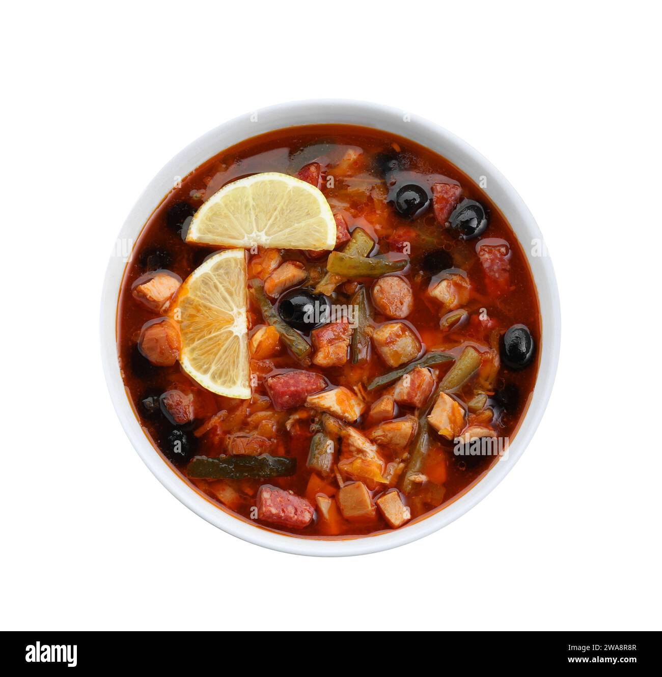 Meat solyanka soup with sausages, olives and vegetables in bowl ...