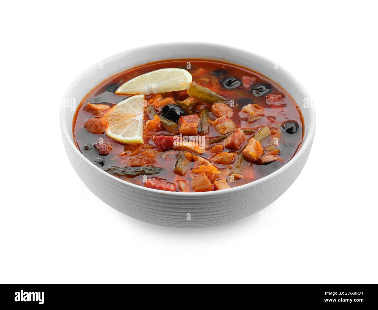 Meat solyanka soup with sausages, olives and vegetables in bowl ...