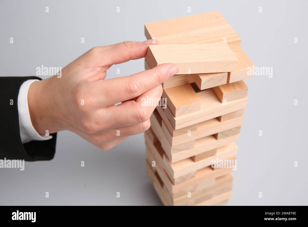 Woman playing Jenga on light gray background, closeup Stock Photo - Alamy