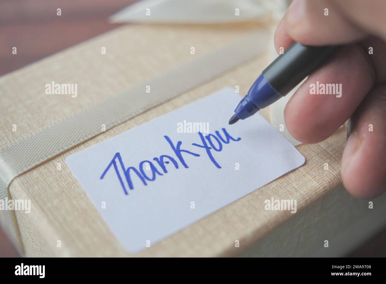 thank you note and gift box on black background Stock Photo - Alamy