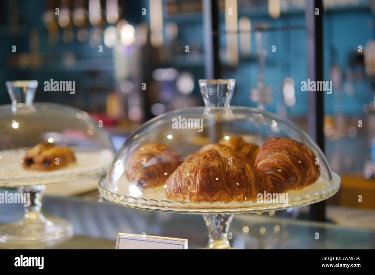 vertical sho or fresh baked croissant in a glass transparent container ...