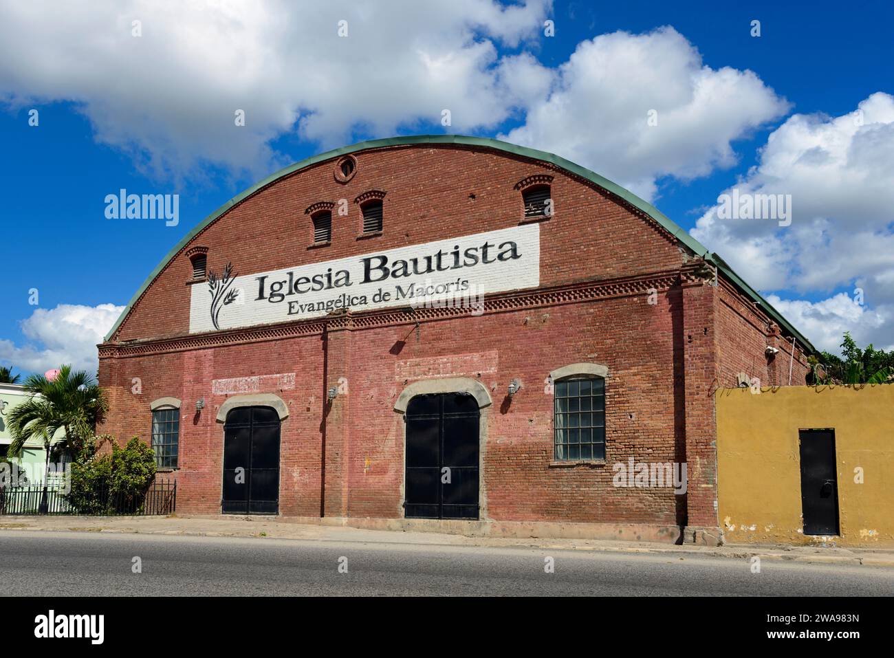 Red brick church under a blue sky with a few clouds, Protestant Baptist ...