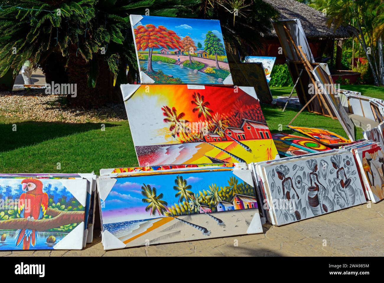 A collection of colourful paintings presented on a sunny day outdoors ...