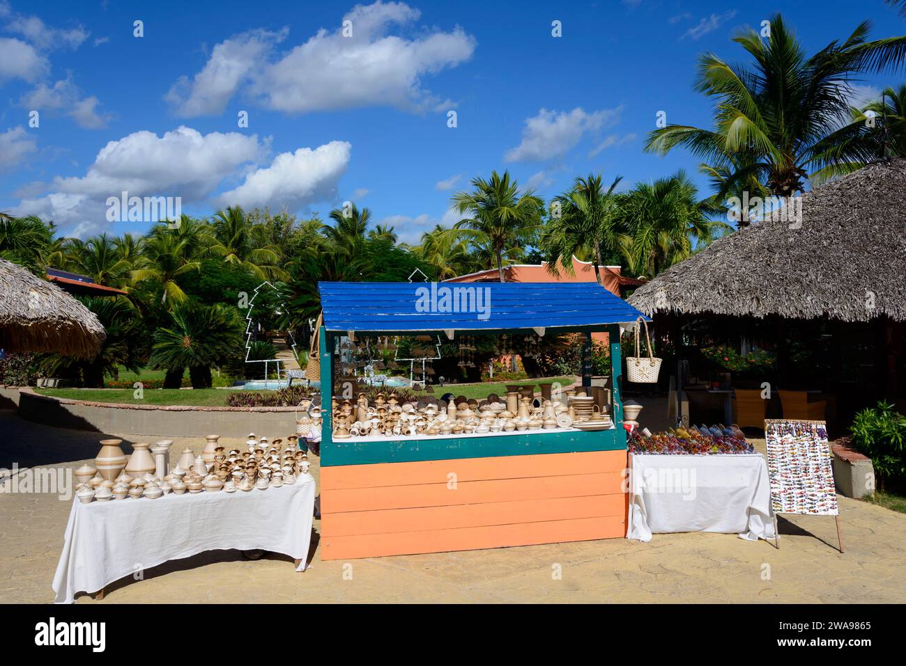 A market stall with souvenirs on a sunny tropical beach surrounded by ...