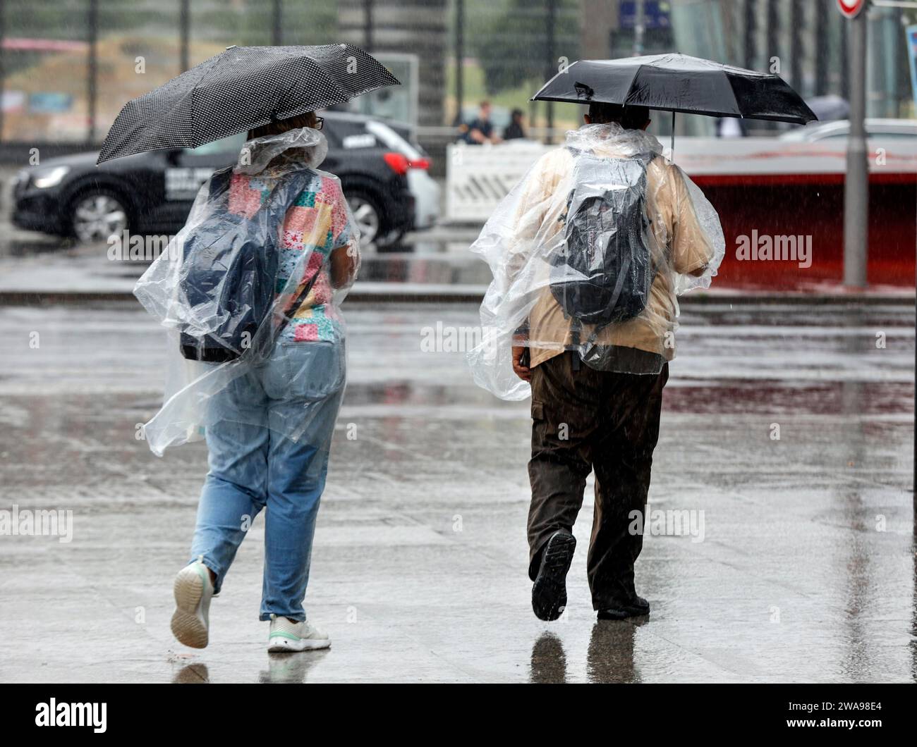 Tourists with rain capes and umbrellas during heavy rainfall, Berlin ...