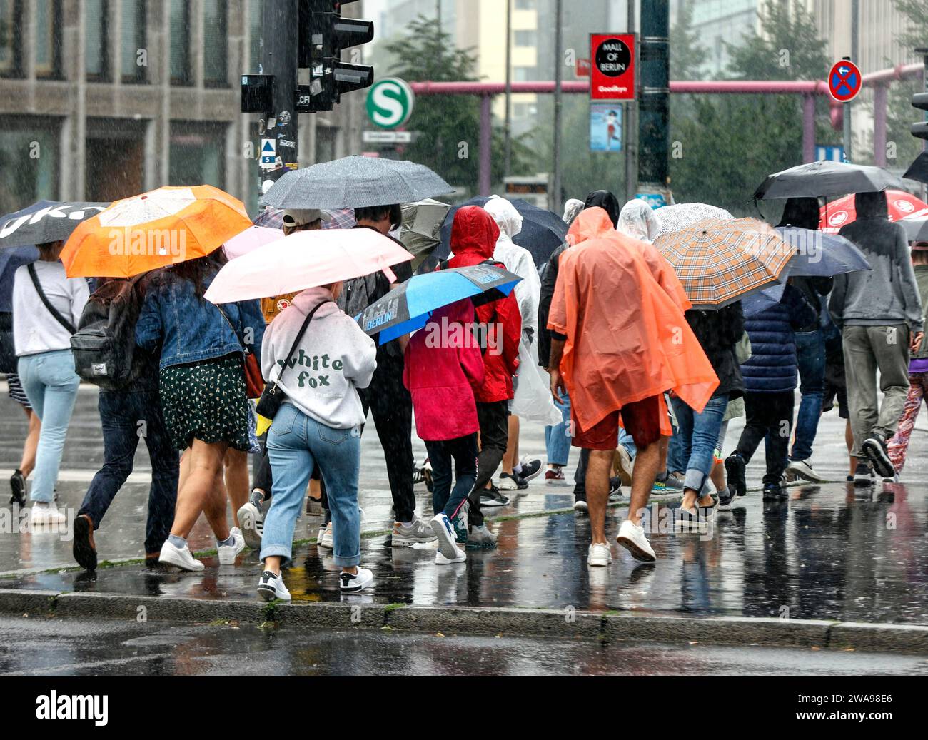Tourists with rain capes and umbrellas during heavy rainfall, Berlin ...