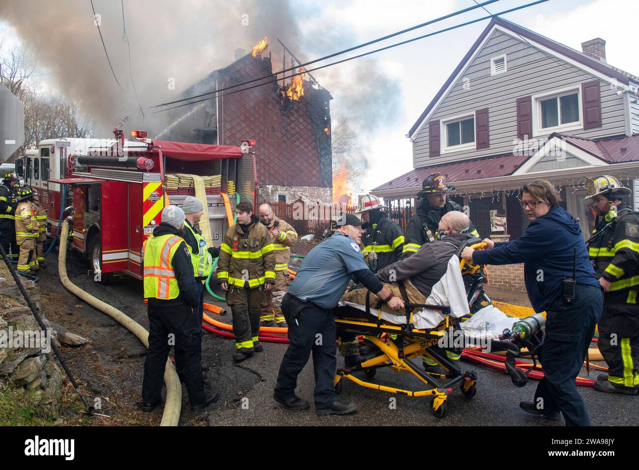 A firefighter is wheeled by paramedics from the scene of a fire in Palo ...